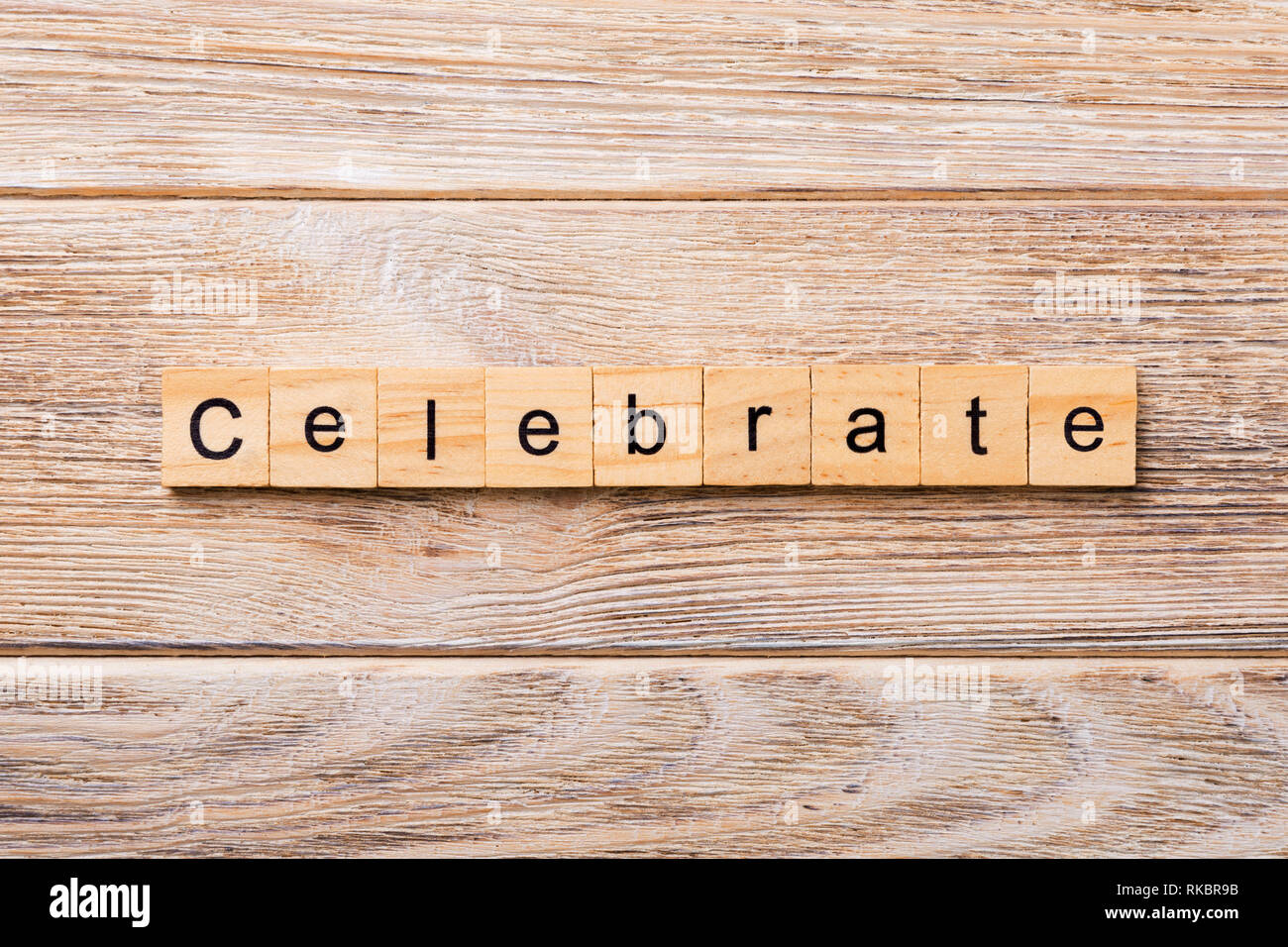 Celebrate word written on wood block. Celebrate text on wooden table ...