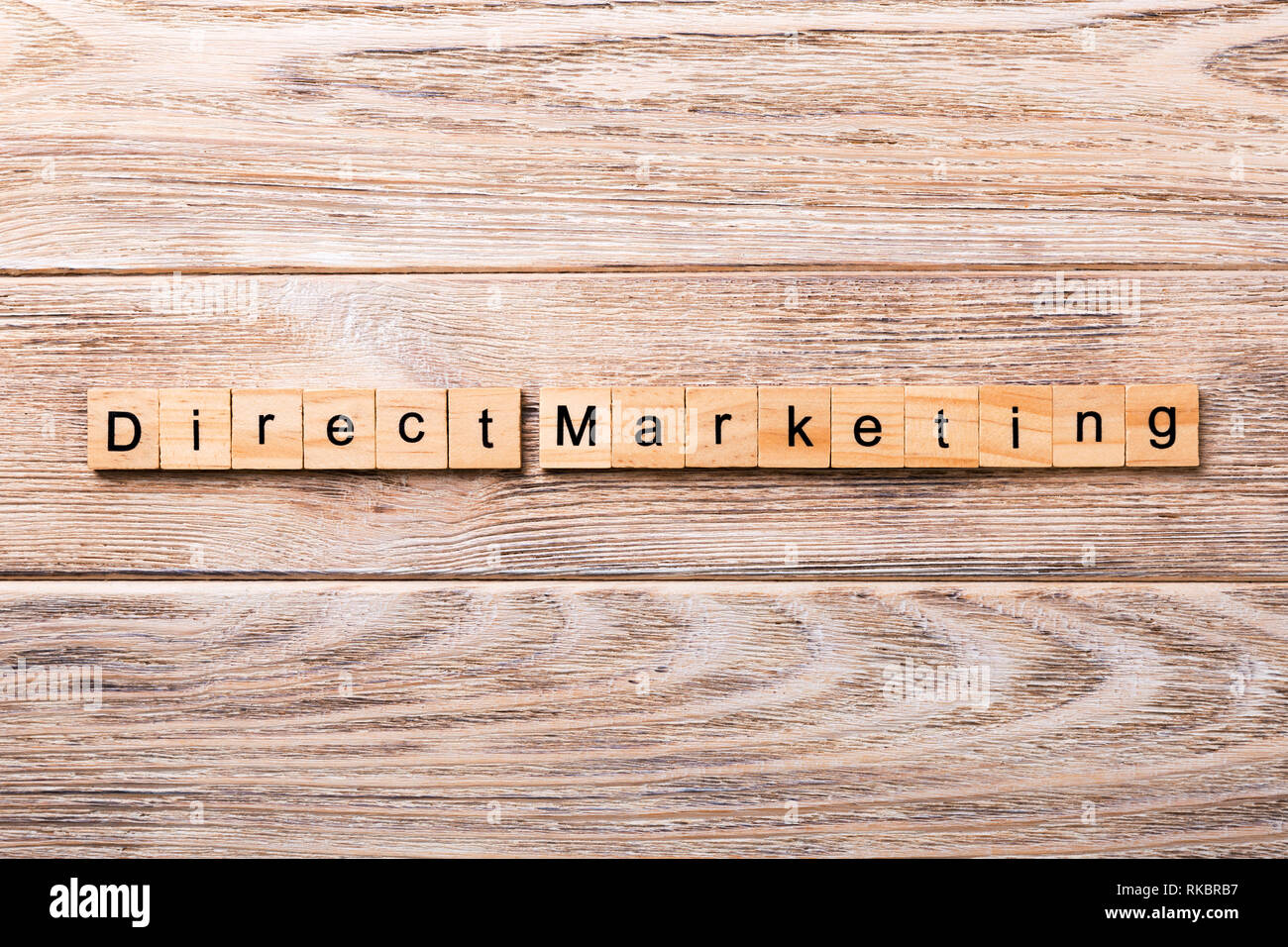 Direct marketing word written on wood block. Direct marketing text on ...