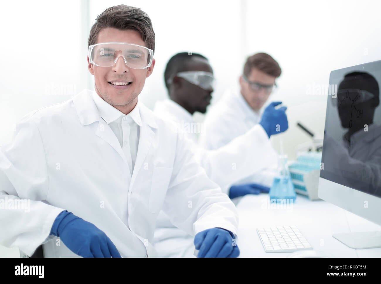 modern scientist sitting in front of a computer monitor. science and ...