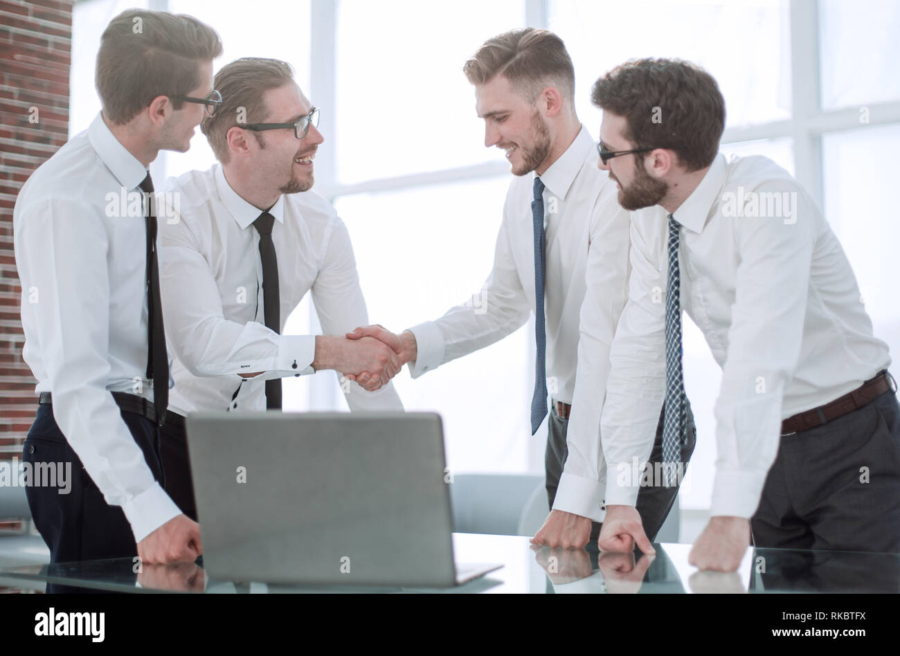 close up.the handshake of the staff near the Desk in the office.the ...