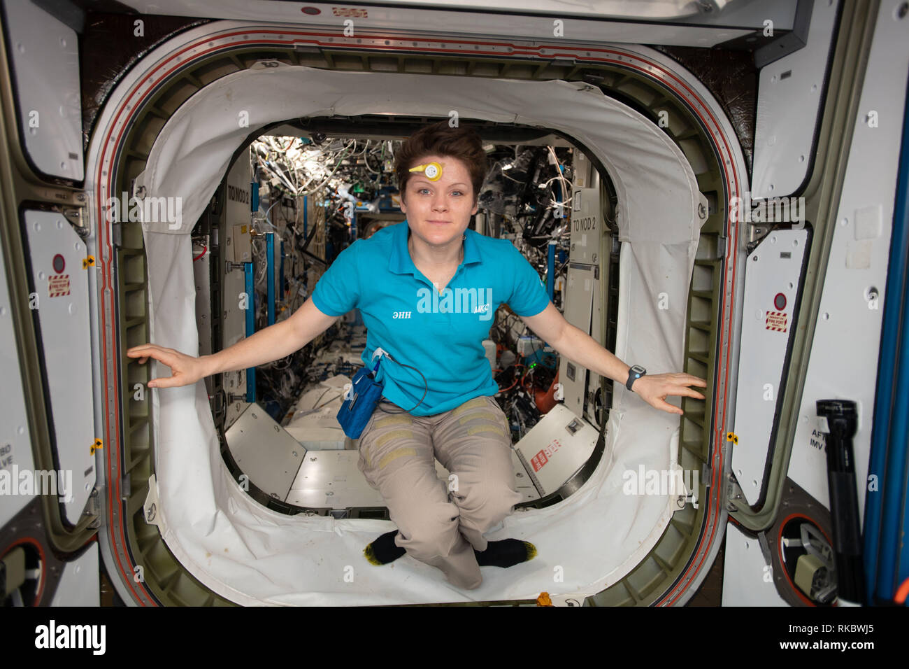 NASA astronaut Anne McClain stands inside the vestibule between the ...