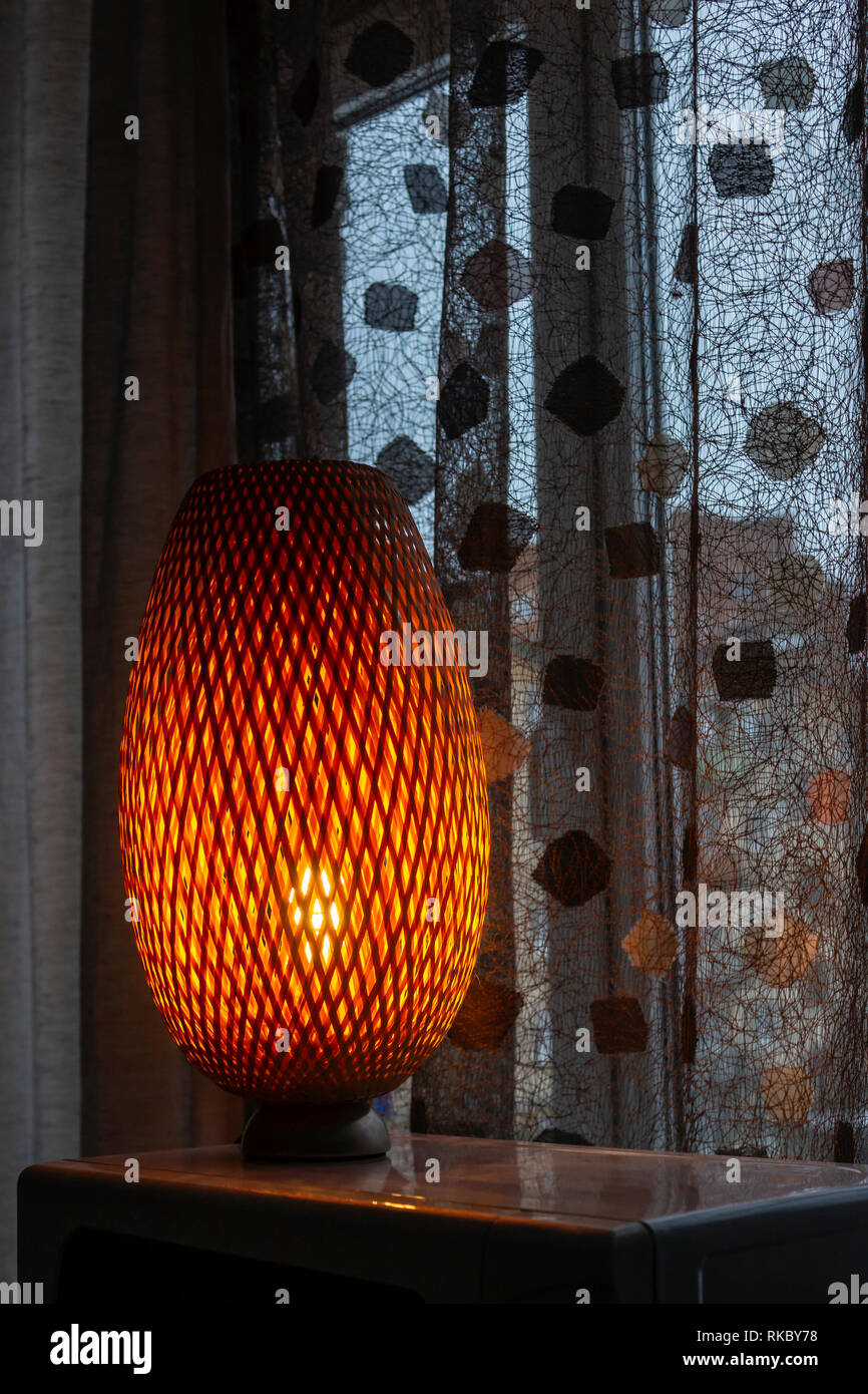 Warm light of lamp near window in interior Stock Photo - Alamy