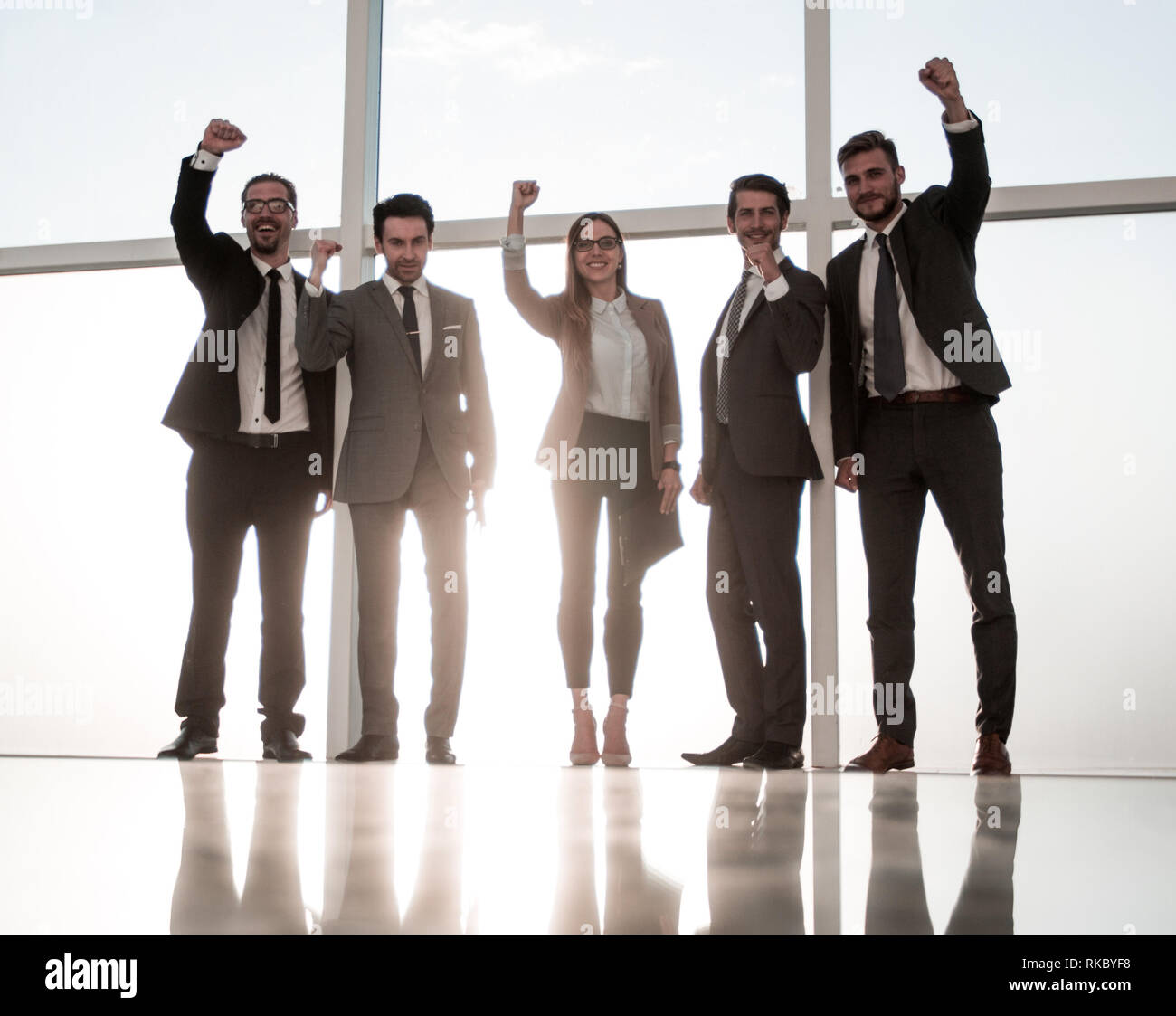 triumphant men and women in formal wear standing in line near panoramic ...