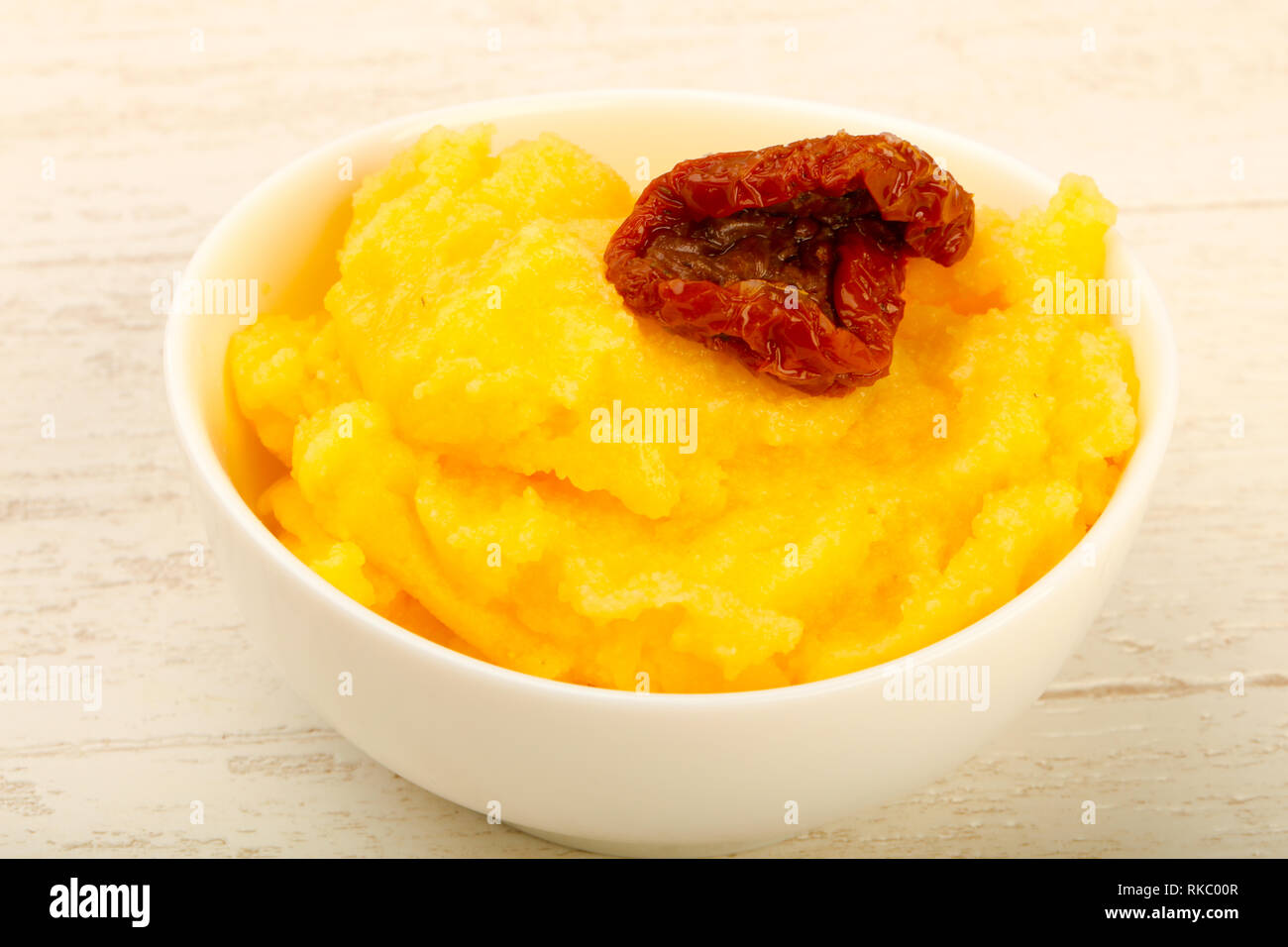 Polenta with dry tomato Stock Photo - Alamy