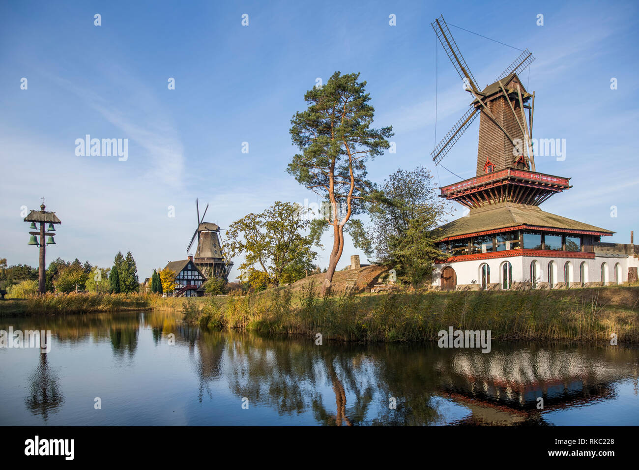 Colorful windmill standing on the shore of the lake in autumn Stock ...