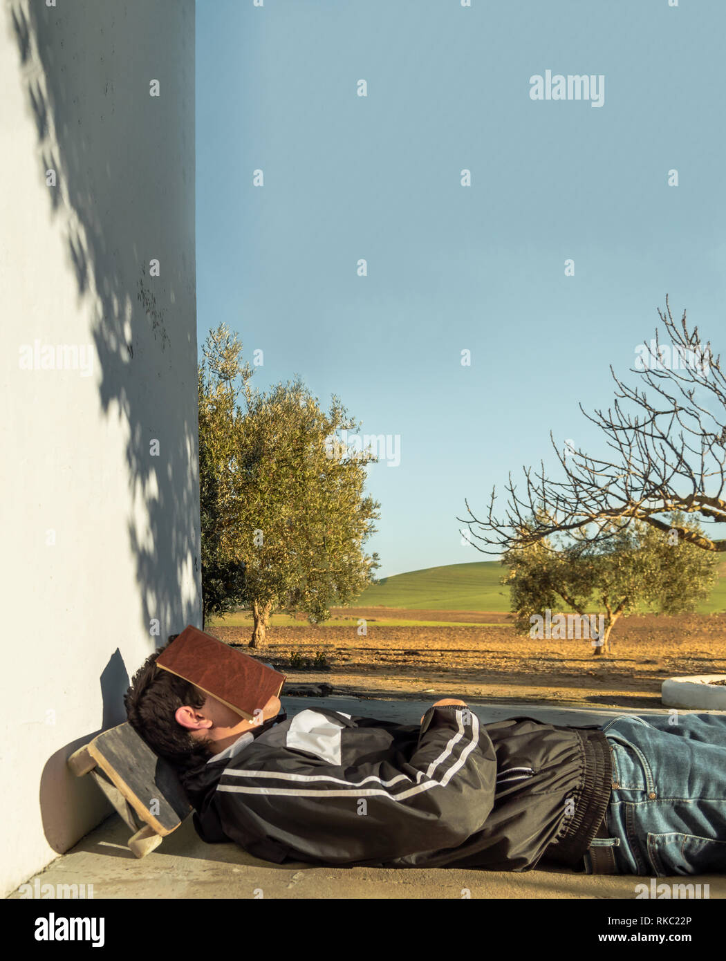 Young man falls asleep on the floor with his head resting on a ...
