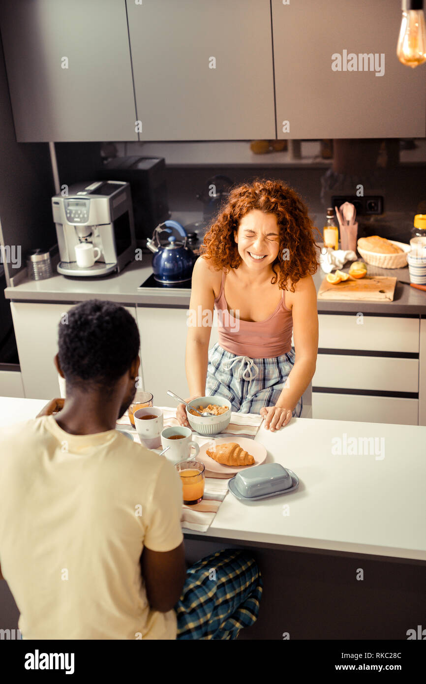 Cheerful girlfriend feeling happy eating breakfast with boyfriend Stock ...
