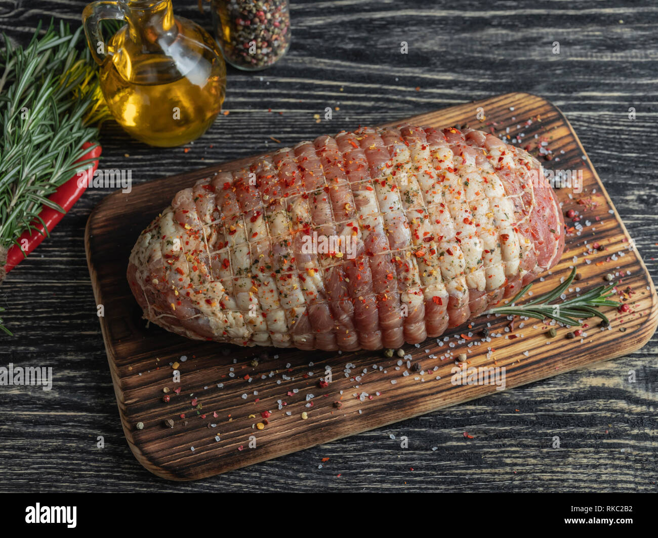 Raw pork roulade. Raw rolled meat enclosed in tied netting. Meat pulp ...