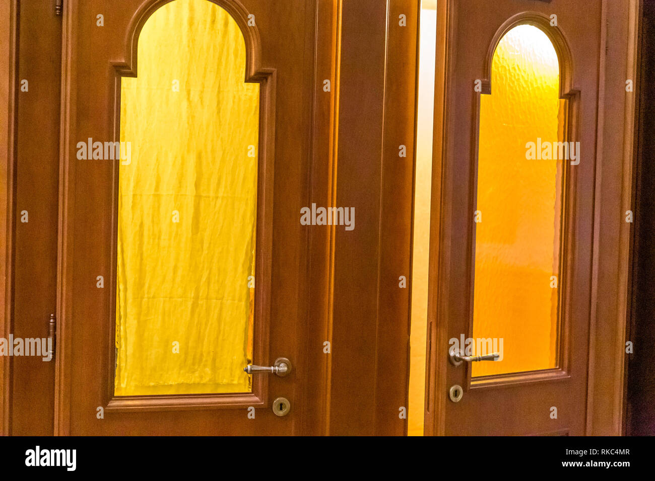 lights behind doors of confessional Stock Photo - Alamy