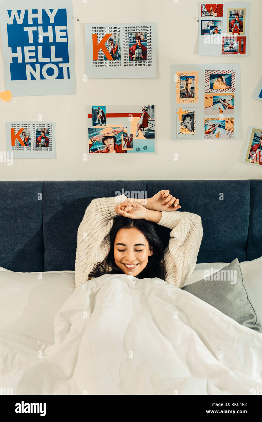 Beaming happy businesswoman feeling happy lying in her bed Stock Photo ...