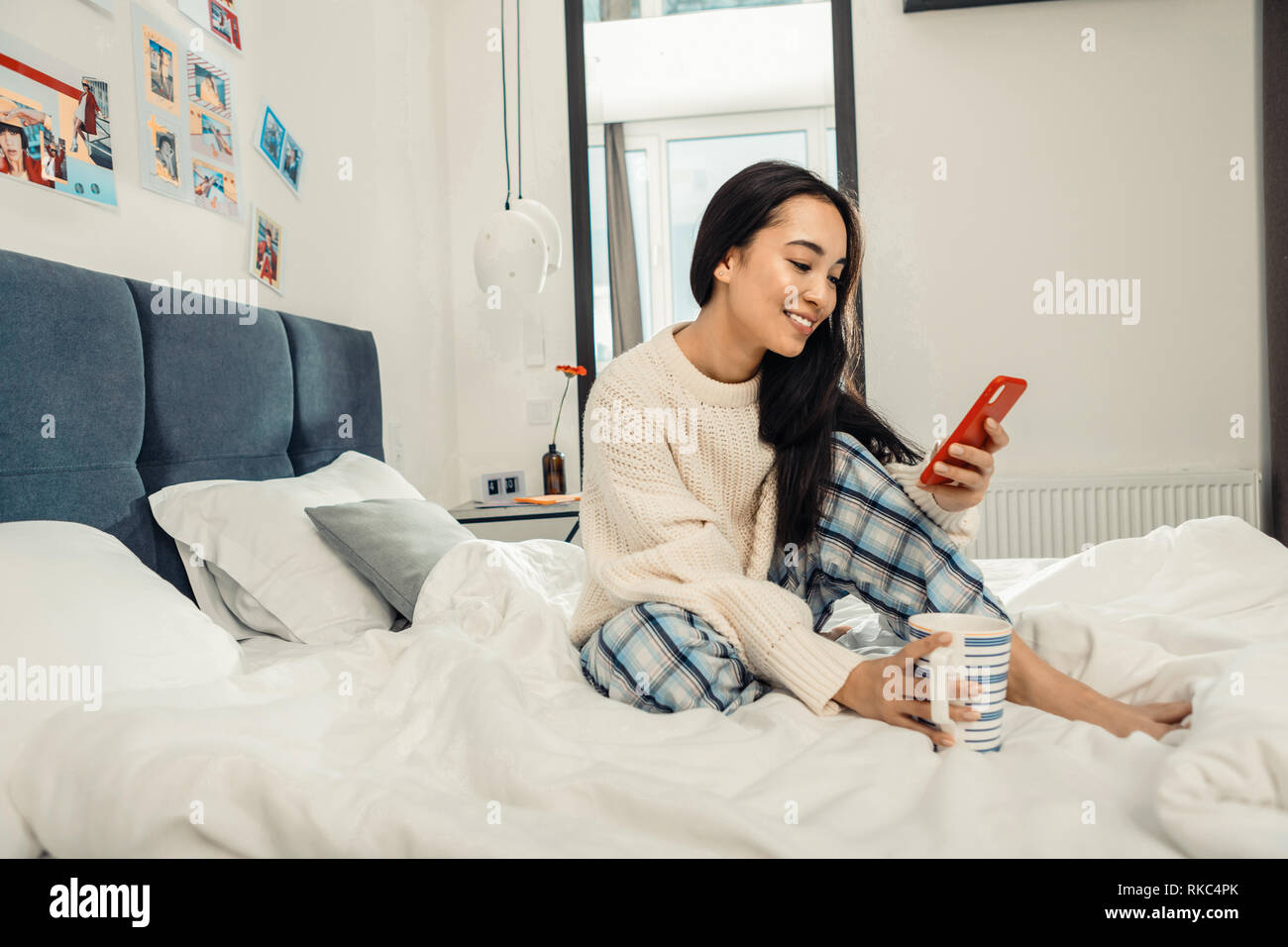 Famous freelancer holding her smartphone while watching photos Stock ...
