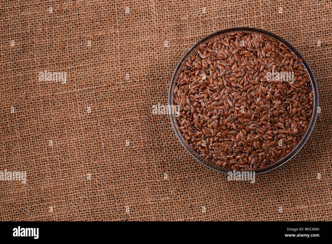 Raw flax seeds seeds in glass bowl on darck background top view, space ...