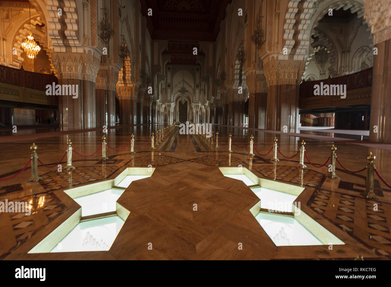 Illuminated grand corridor and pools in the interior of the historic ...