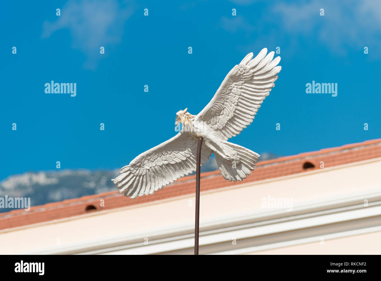 white dove sculpture on a pole in front of the princes' palace in ...