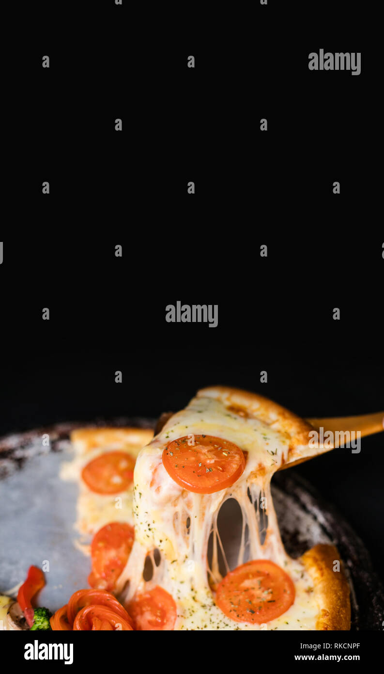 Delicious cheese stringy slice lifted of full supreme pizza margarita ...