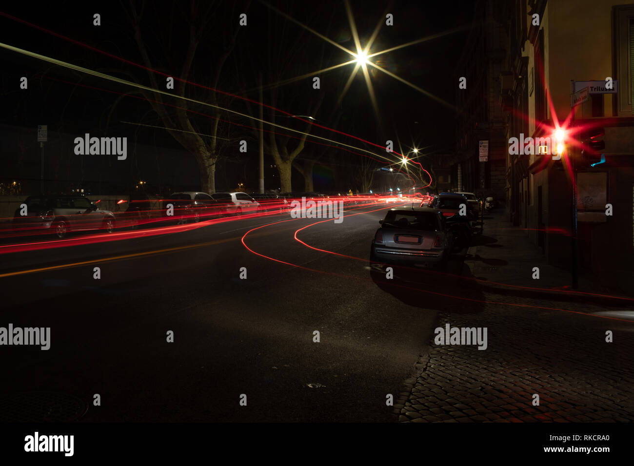 Red trails of the traffic lights in Trastevere district, Rome, Italy ...