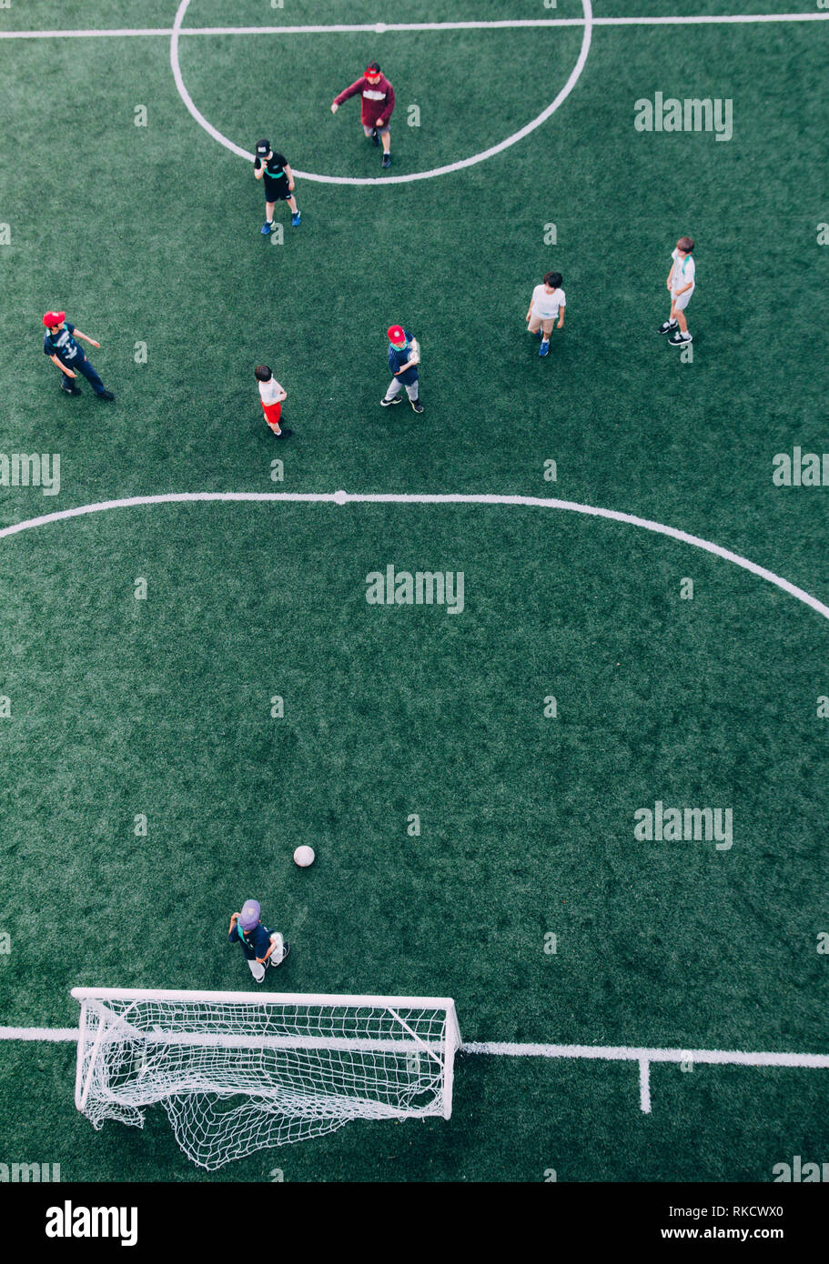 Children kicking ball High Resolution Stock Photography and Images - Alamy