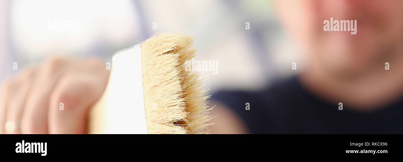Arm of smiling worker hold brush closeup Stock Photo - Alamy