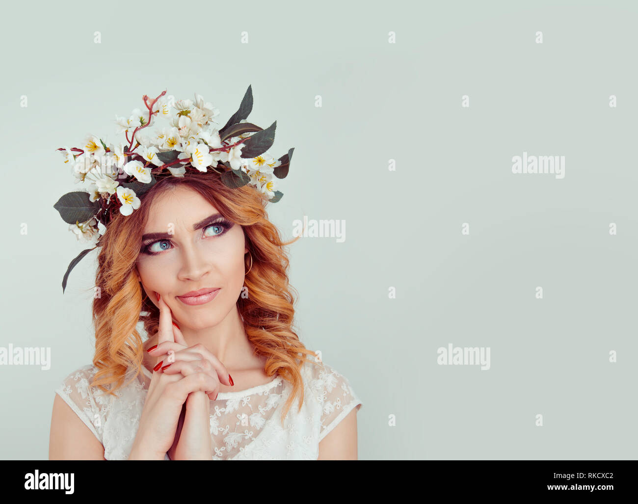 Girl thinking finger on cheek hi-res stock photography and images - Alamy