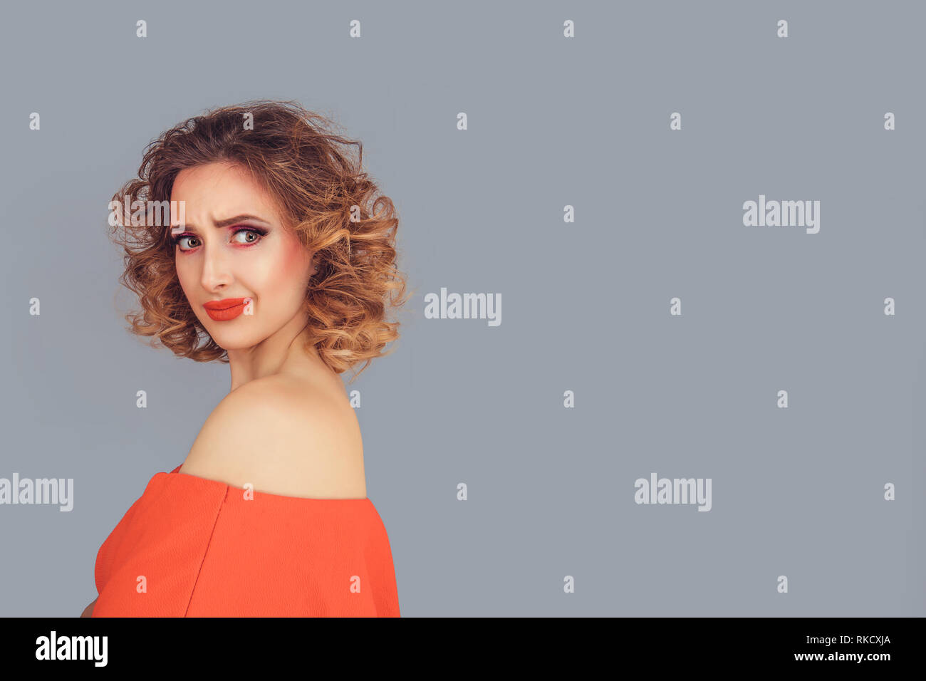 Jealous woman looking back to the side disgusted frowning Stock Photo ...