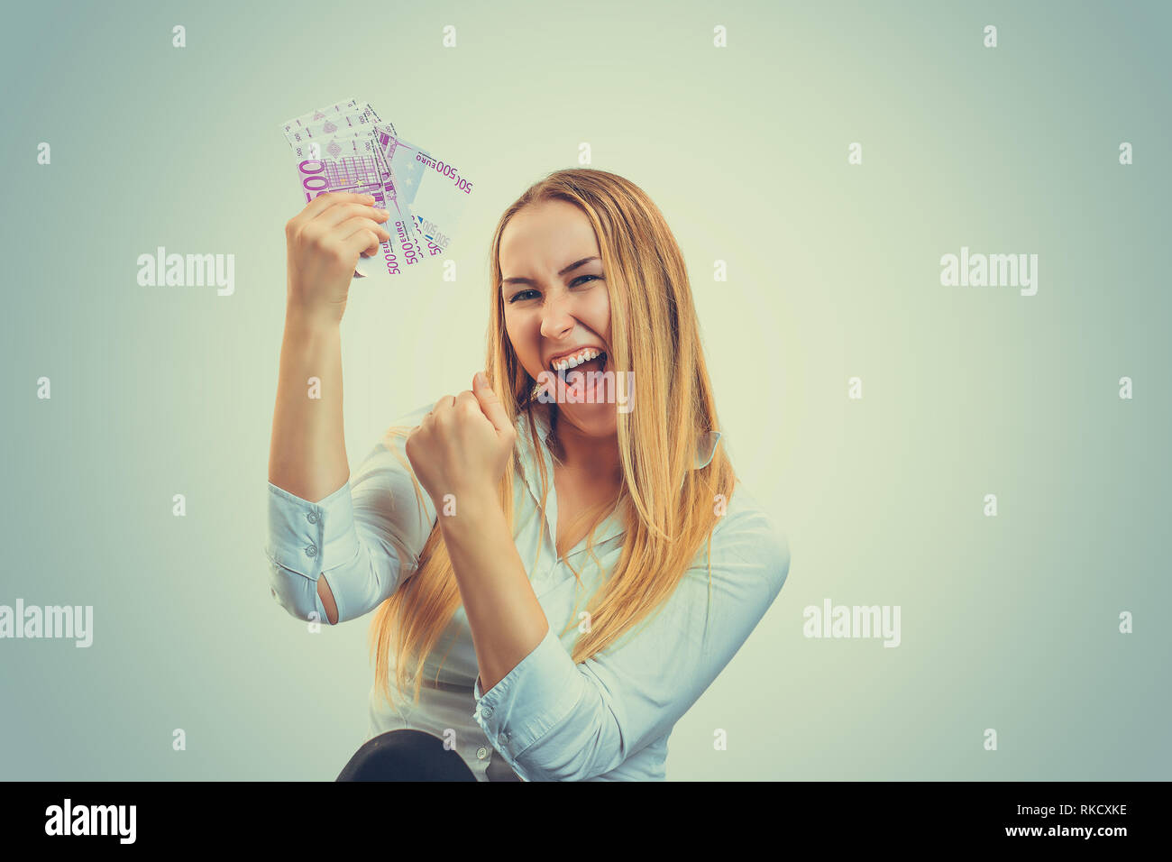 Woman happy holding money Stock Photo - Alamy