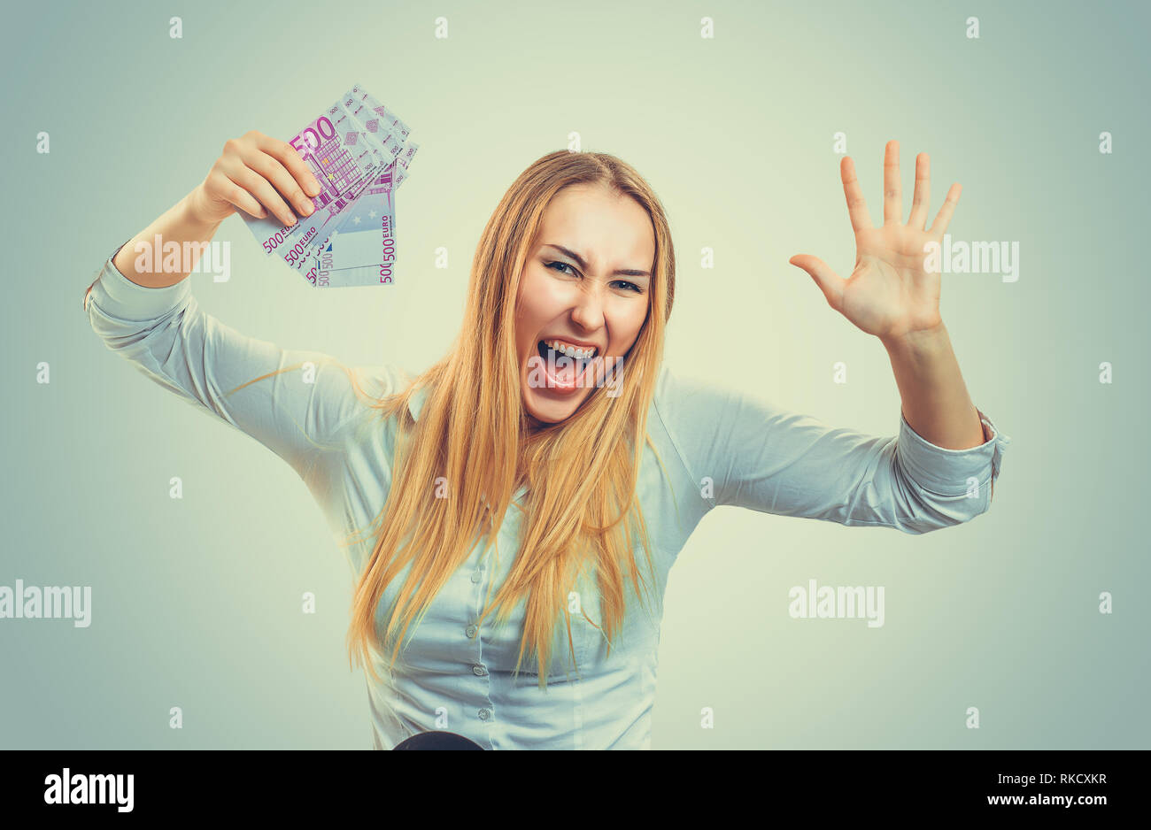 Woman happy holding money Stock Photo - Alamy
