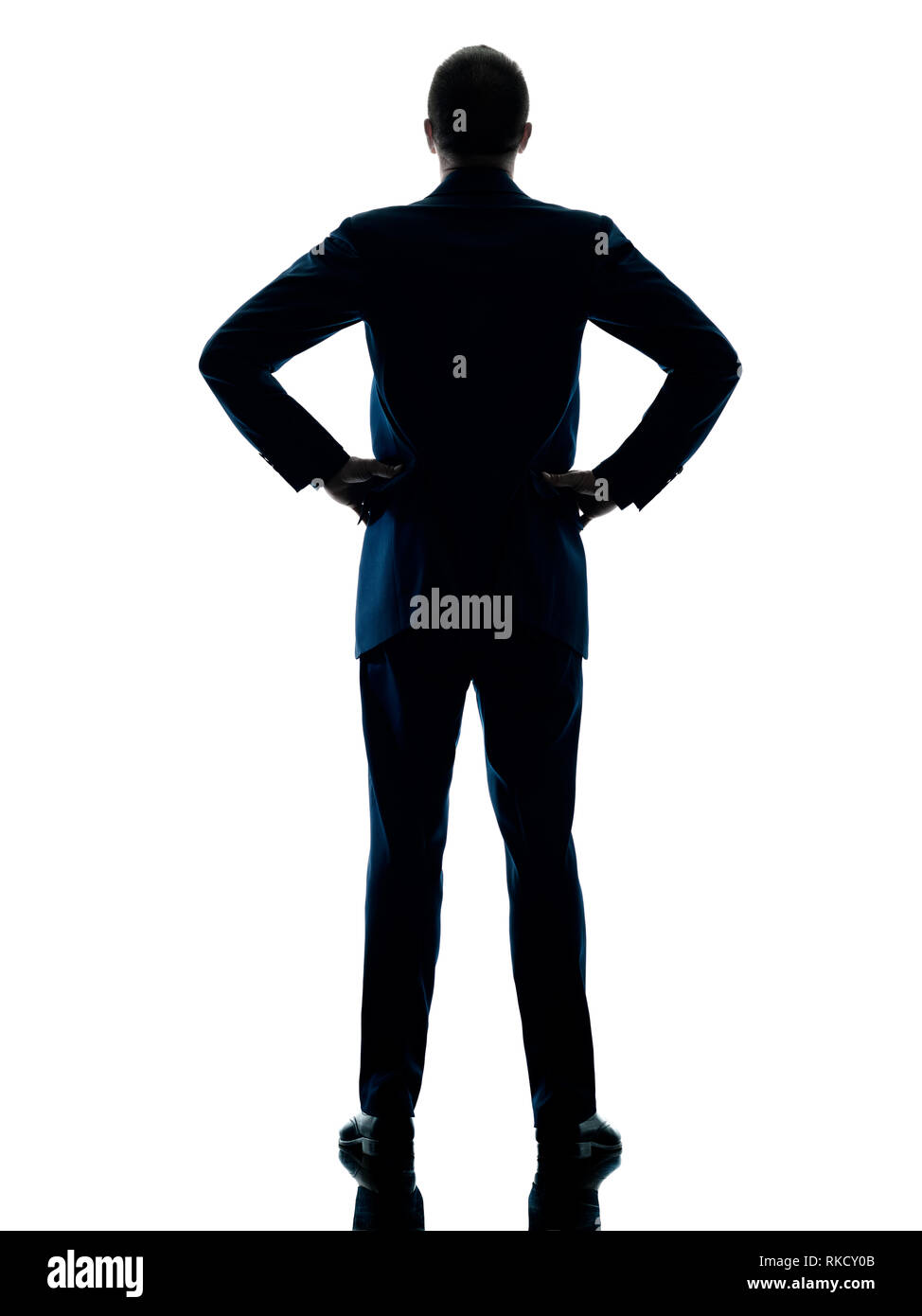 one caucasian business man standing rear view silhouette isolated on ...