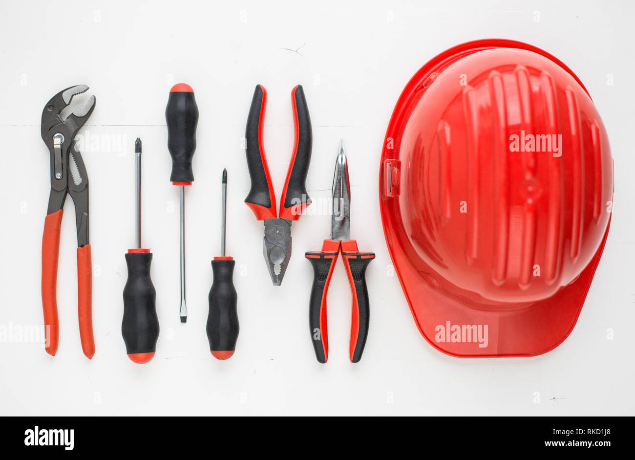 Various hand tool equipment on white table Stock Photo - Alamy