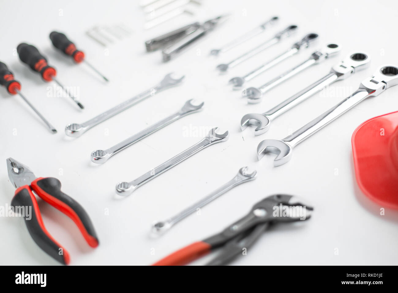 Various hand tool equipment on white table Stock Photo - Alamy
