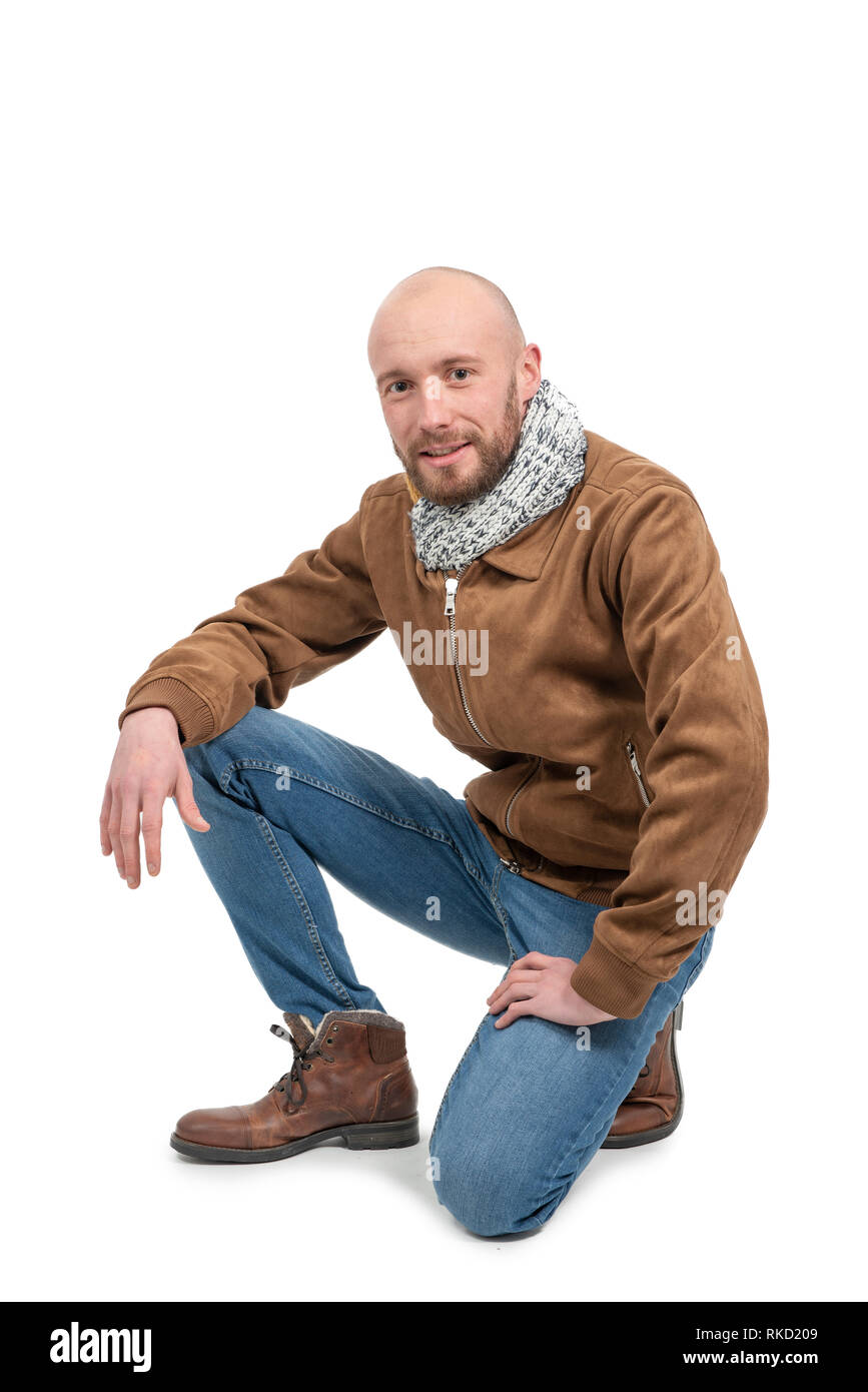 young man with a beard on the ground isolated on a white background ...