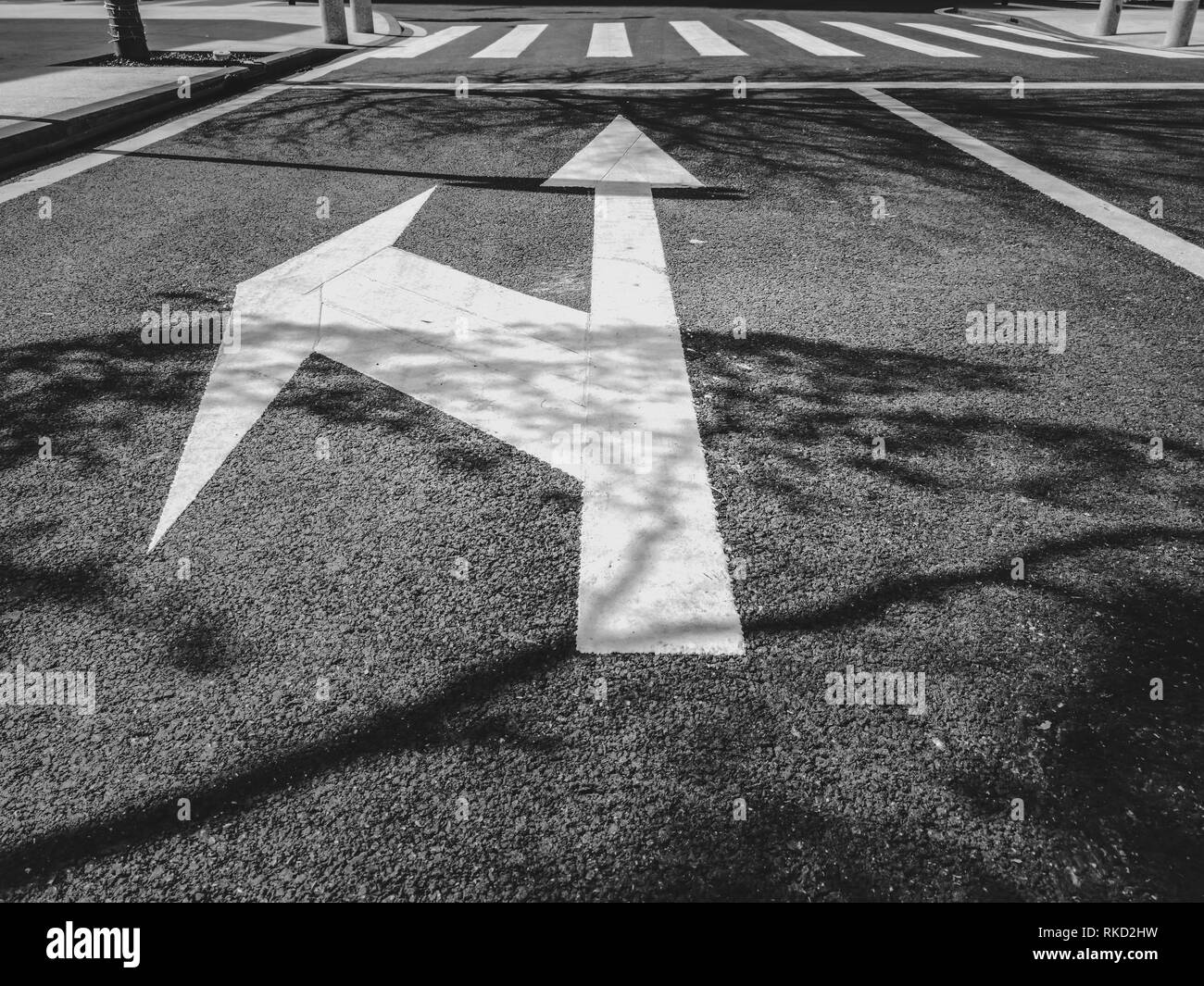 Arrows painted on the road asphalt, safety, black and white style Stock ...