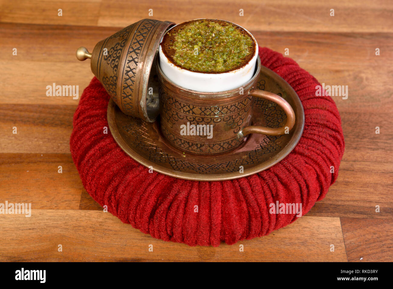 Turkish coffee with hazelnut served in a cup covered by a copper lid ...