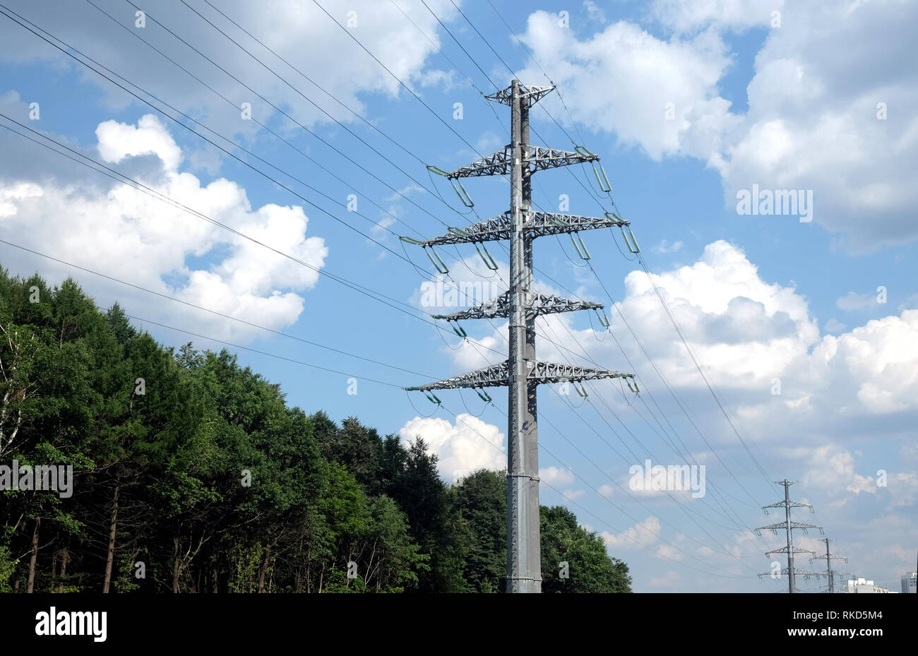 High-voltage power line gray metal props with many wires closeup view ...