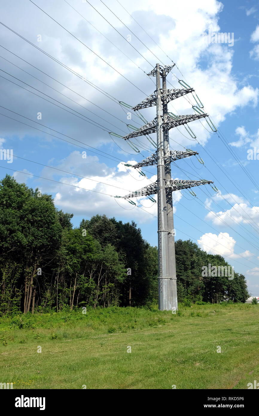 Country landscape with high-voltage power line grey metal prop with ...