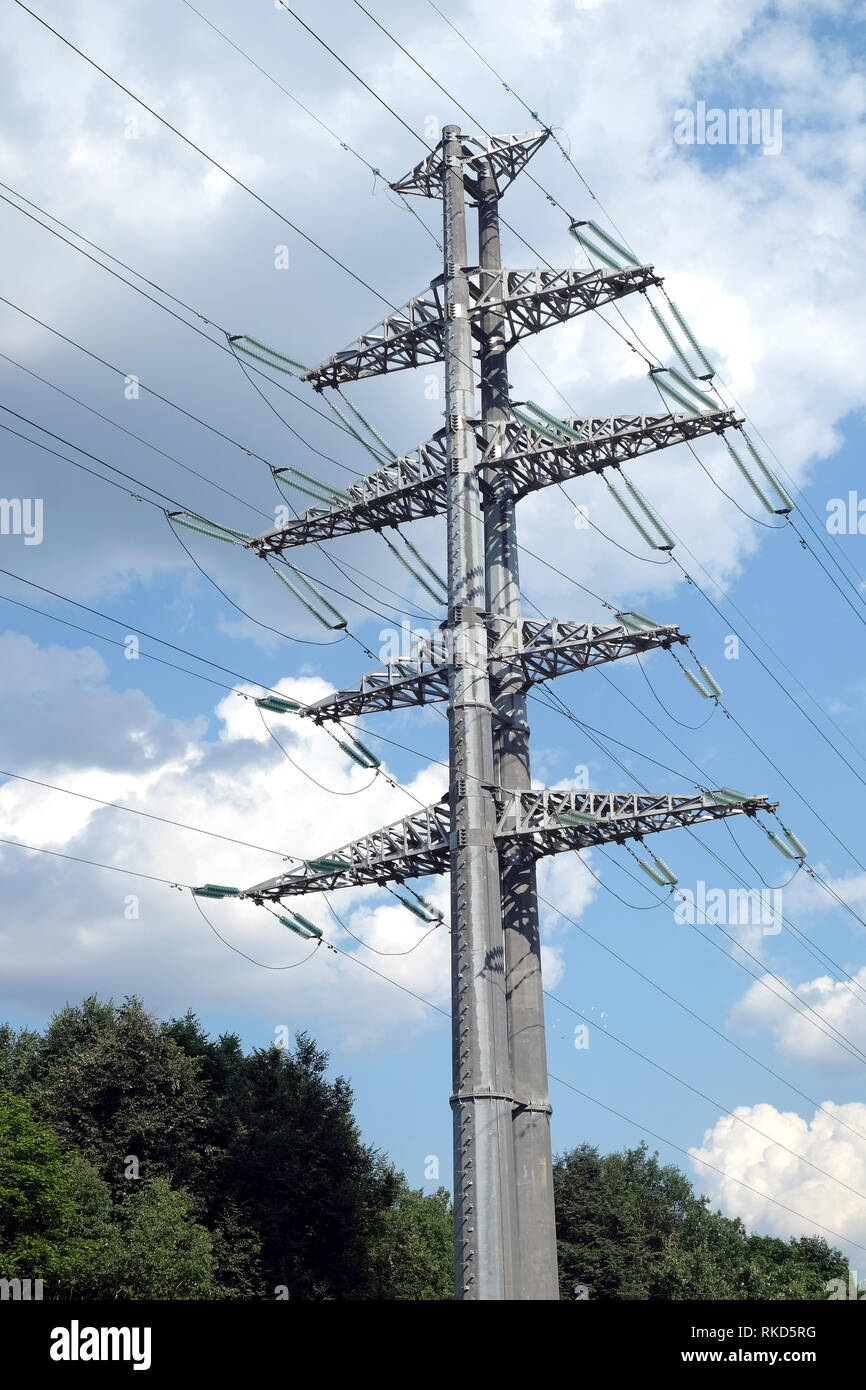 Country landscape with high-voltage power line grey metal prop with ...