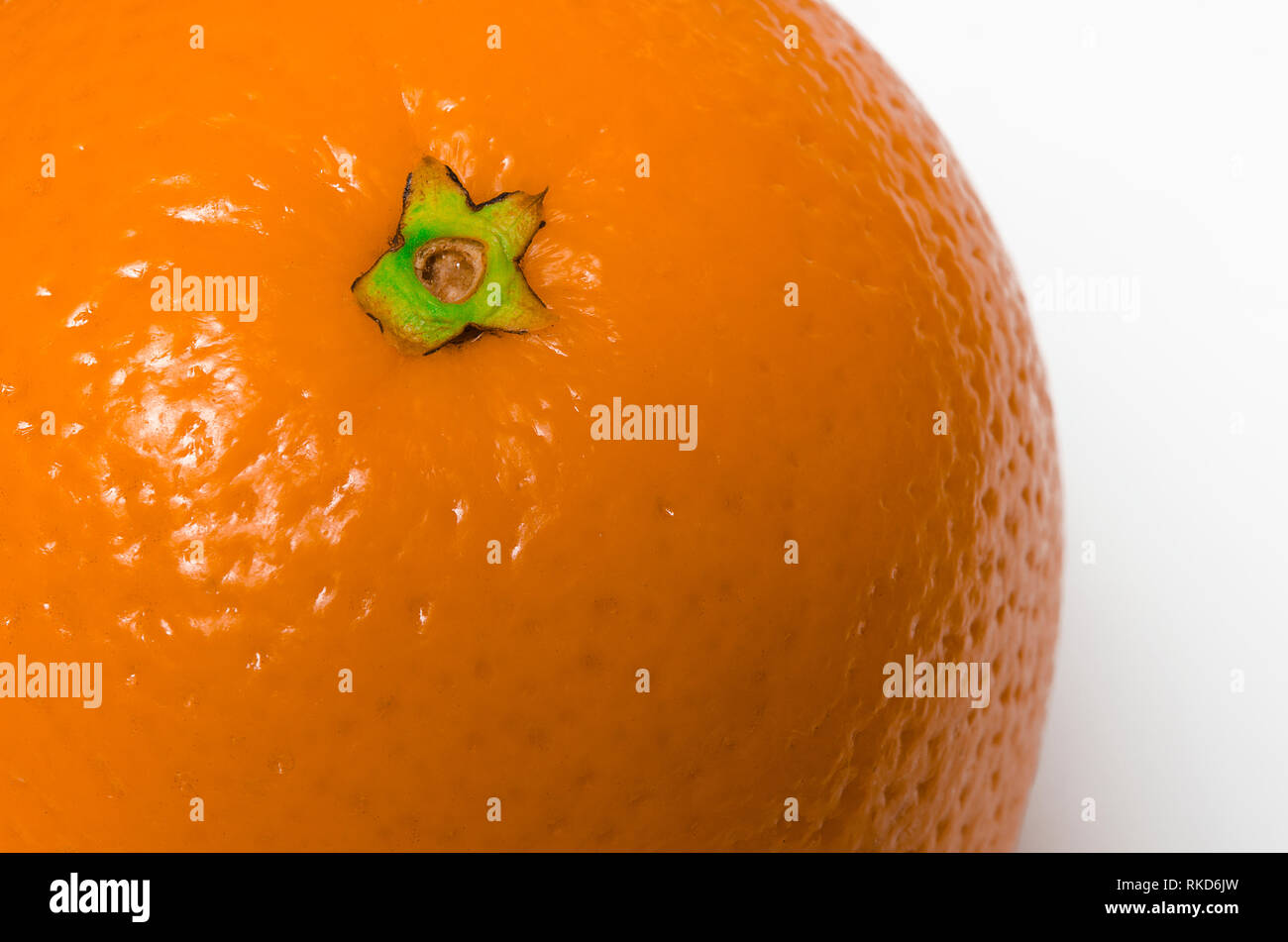 Juicy orange with textured skin closeup lies on a white background with ...