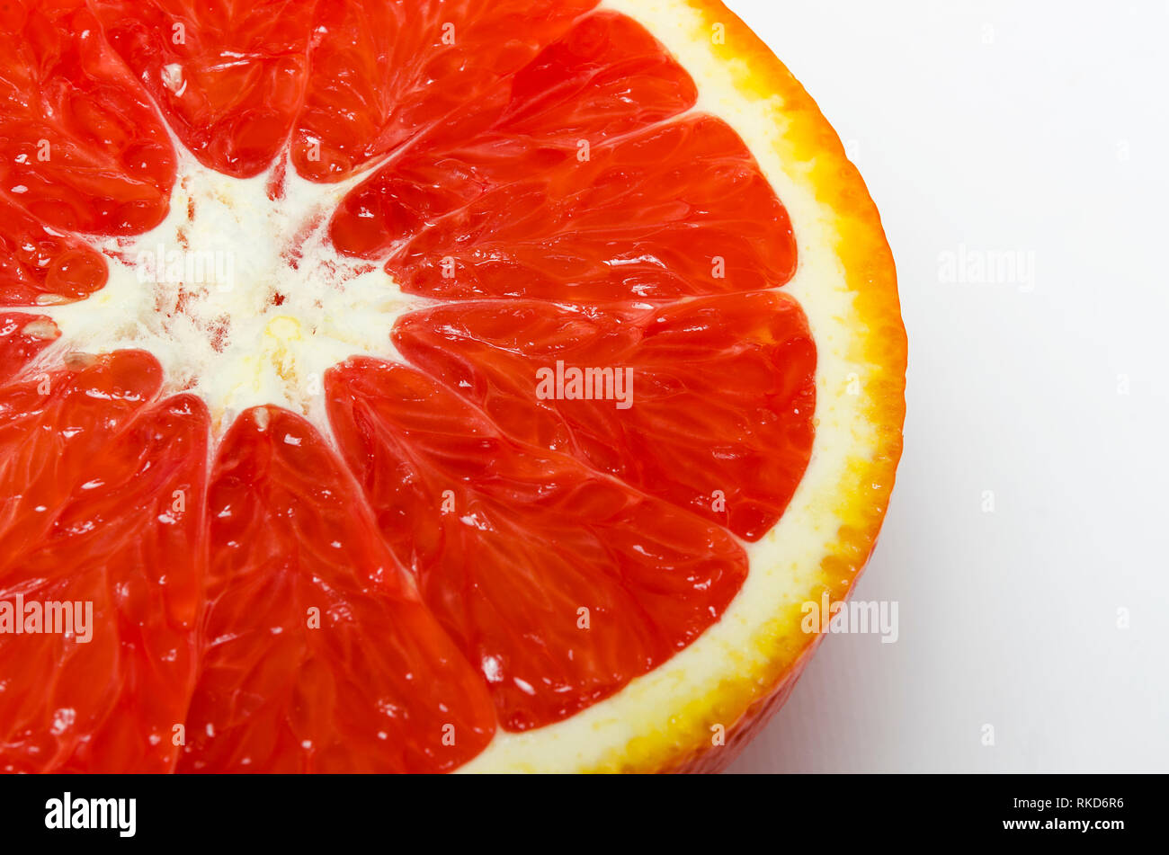 cut juicy red orange close-up lies on a white background with copy ...