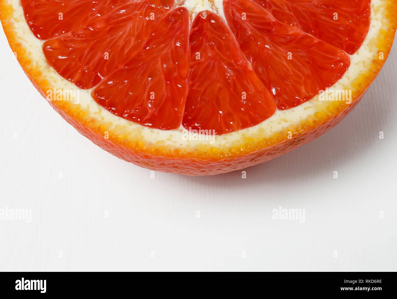 cut juicy red orange close-up lies on a white background with copy ...