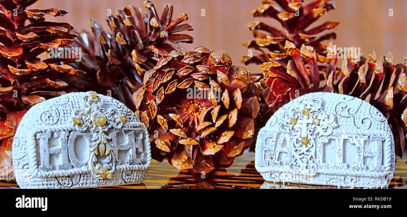 Close-up of several pinecones with two handcrafted stones that have ...
