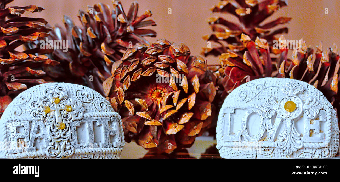 Close-up of several pinecones with two handcrafted stones that have ...