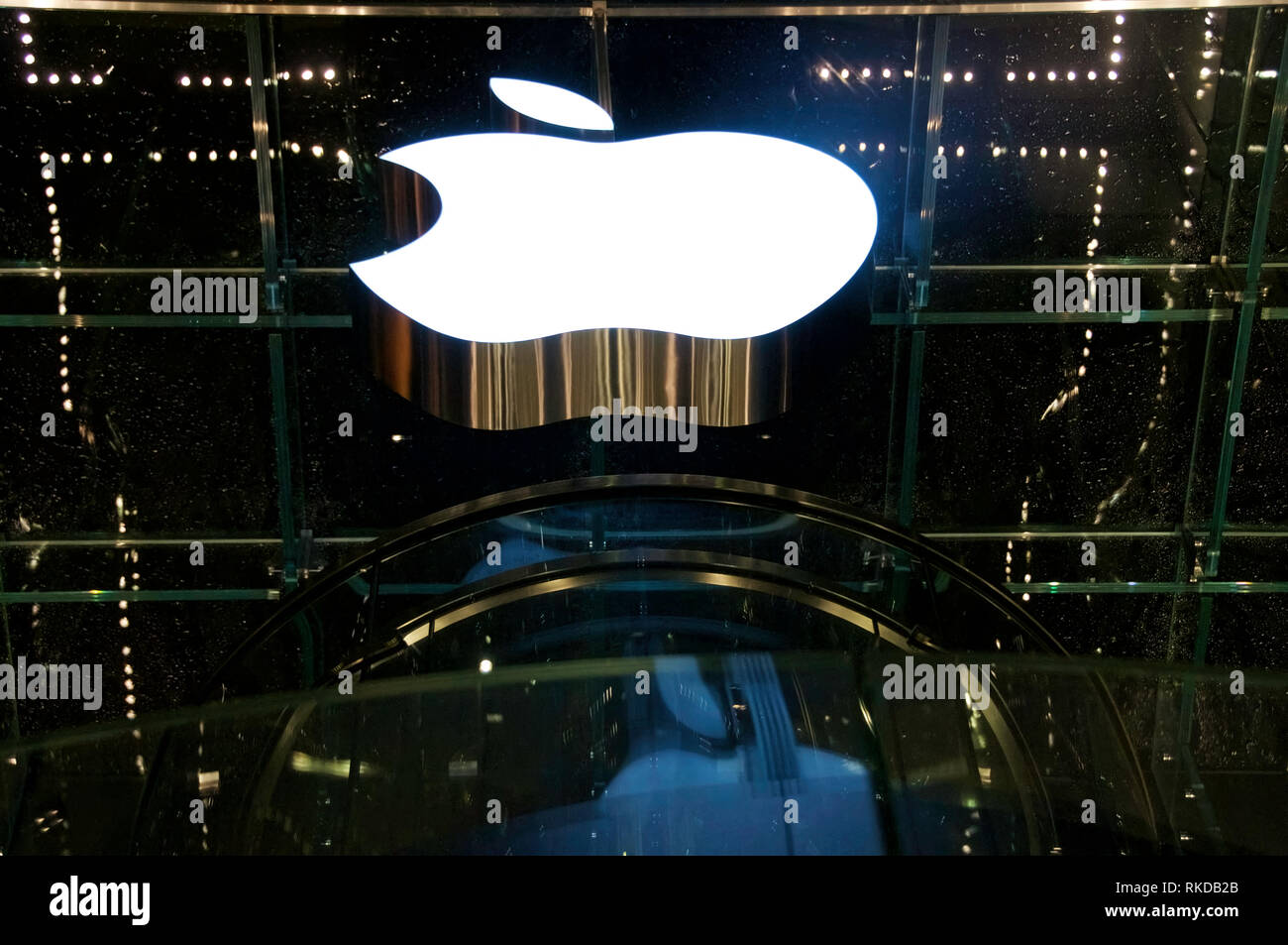 The lighted white logo of Apple at a flagship store in New York City's ...