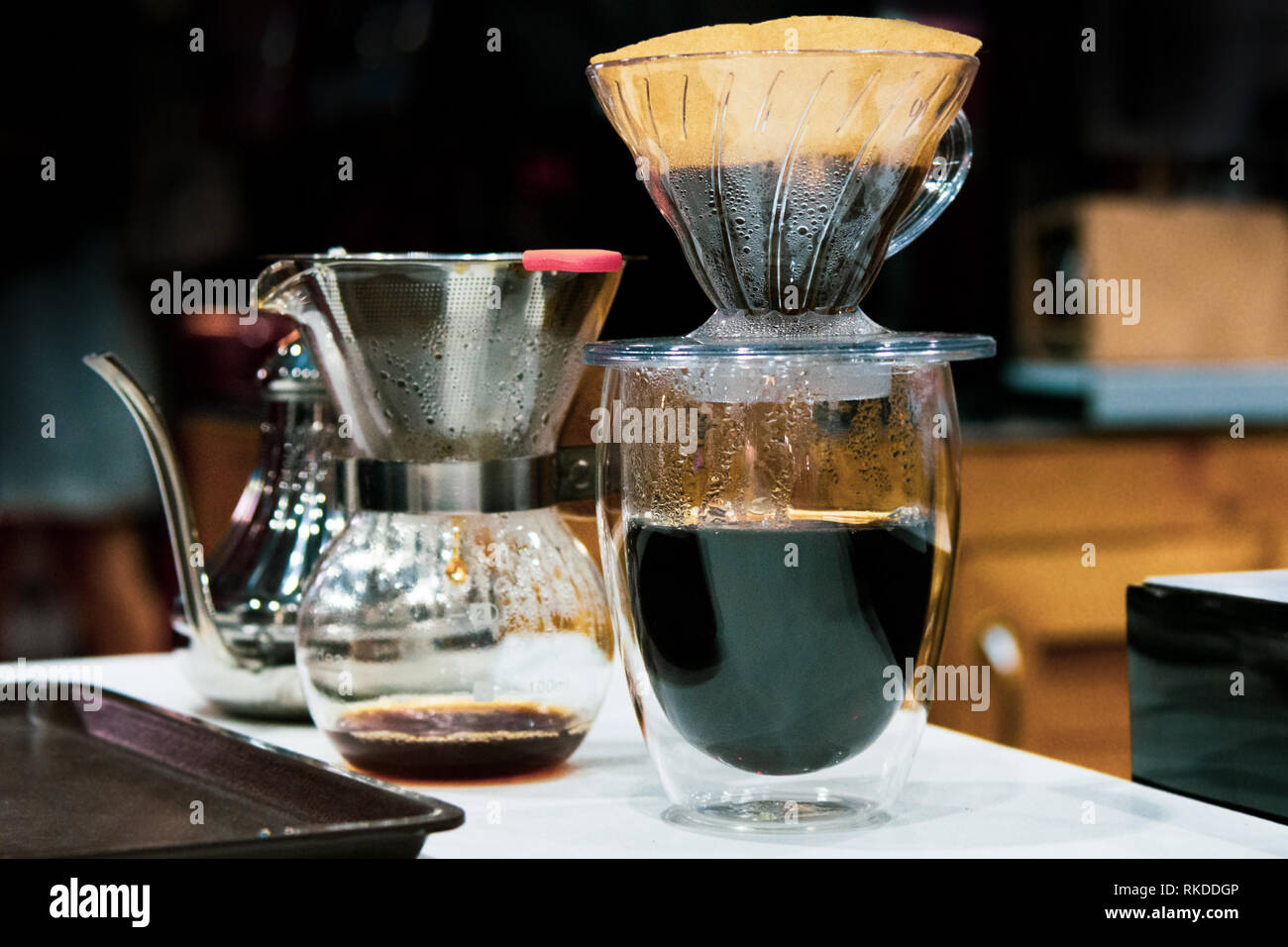Drip coffee brewing, Barista pouring water on coffee ground with filter ...