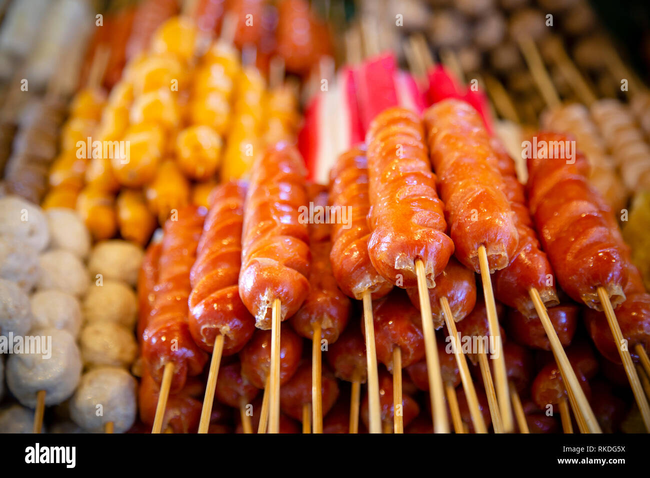 An arrangement of skewered cooked meat and seafood street food snacks ...