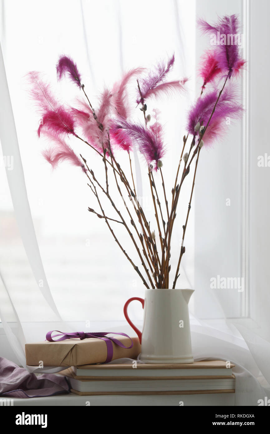 Fastelavnsris decorated with feathres and Fastelavn gifts on a window ...