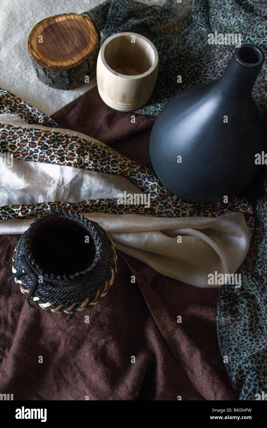 Earthy coloured still life photograph with archaic wooden and ceramic ...