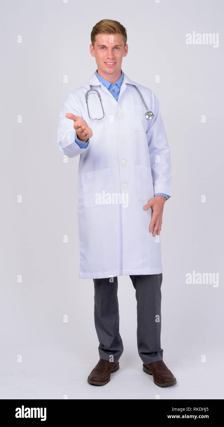 Full body shot of young happy man doctor giving handshake Stock Photo ...