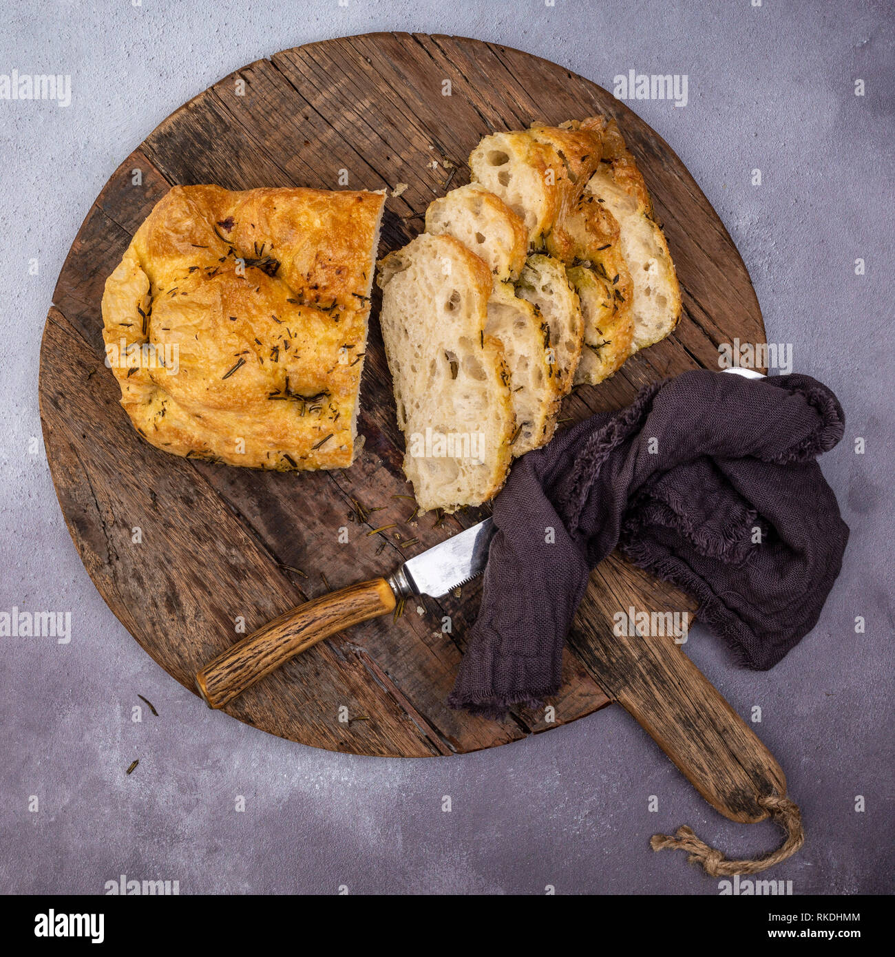 Rosemary & rock salt Focaccia bread on a retro wooden bread board with ...
