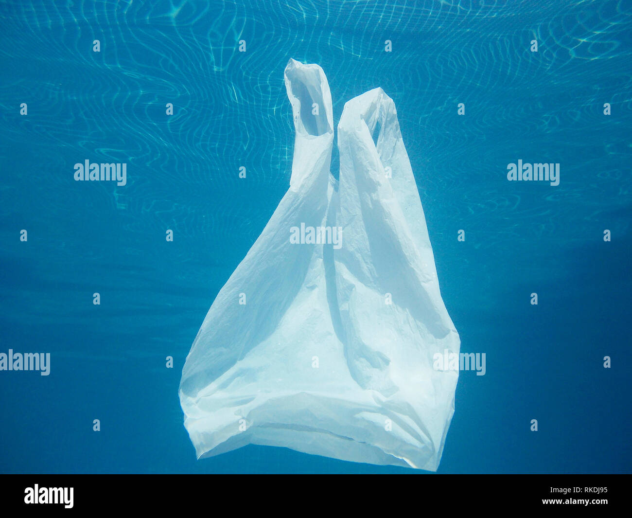 Plastic bag floating into the water. Polluted enviromental. Recycle ...