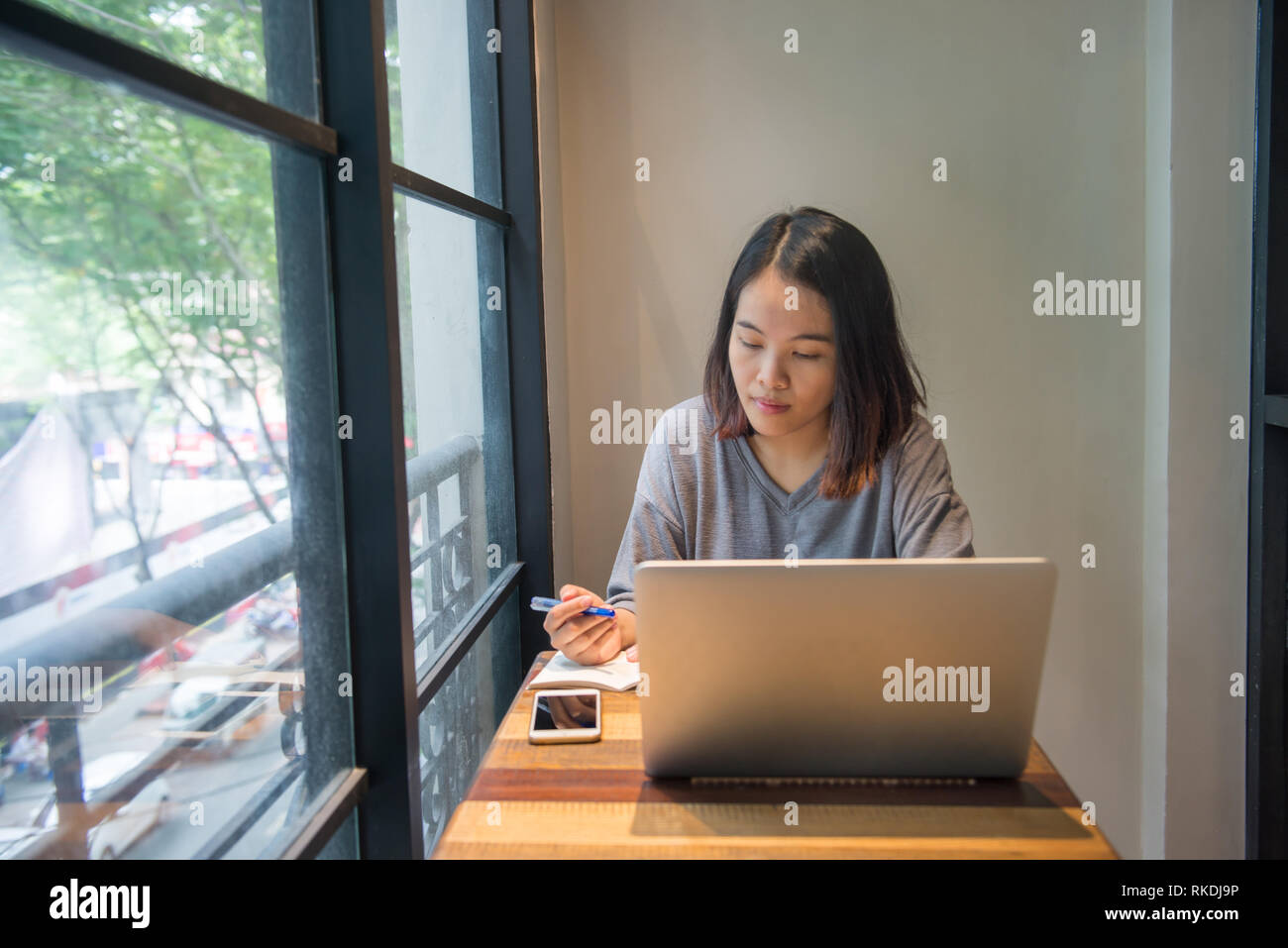 Asian woman writing notes Stock Photo - Alamy