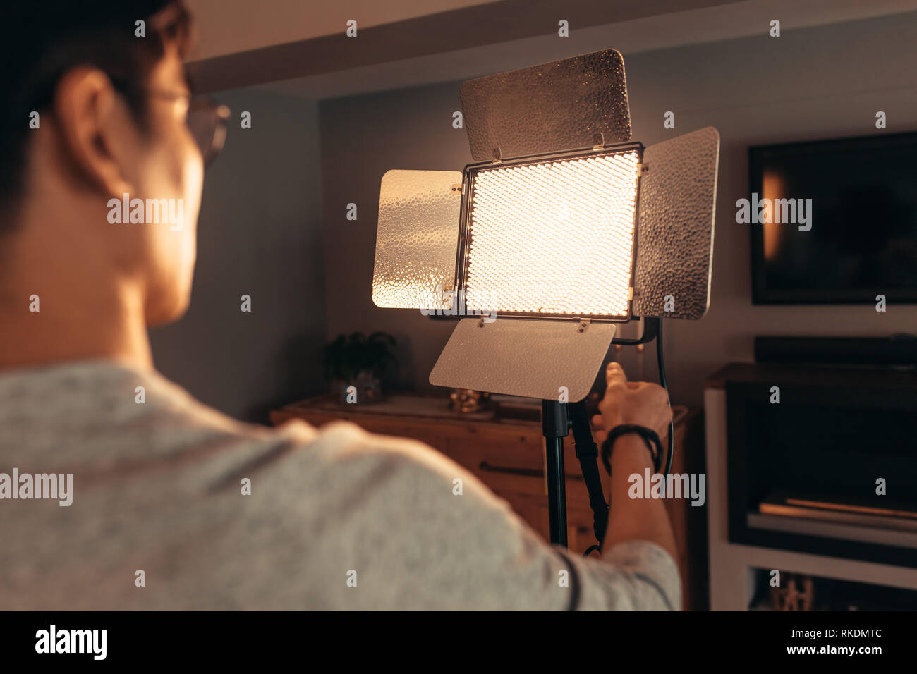 Male photographer accommodates and tries out a flash light setting ...